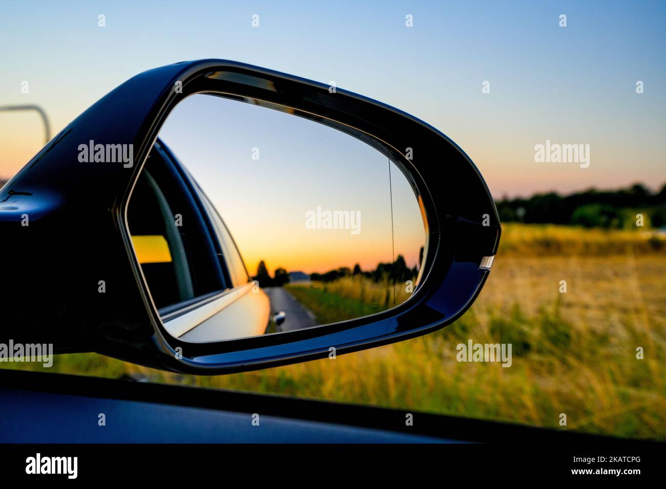 A reflection in the side-view mirror of a car Stock Photo - Alamy