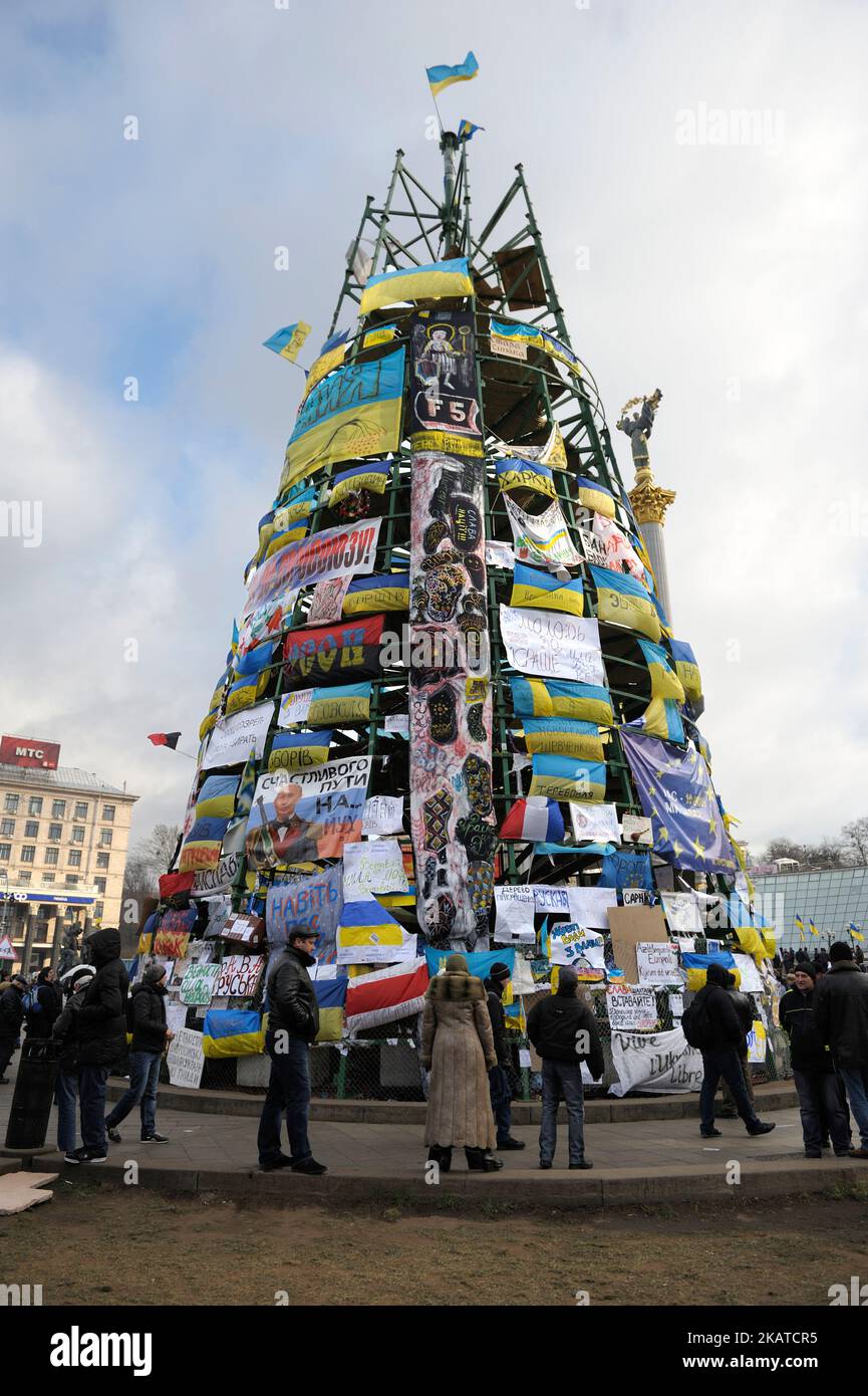 Posters, flags, signs put on a frame of New Year Christmas Tree set on ...