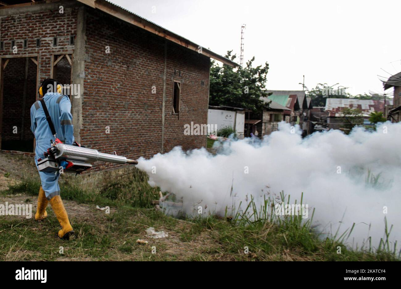 A health worker fumigation densely populated areas to prevent the ...