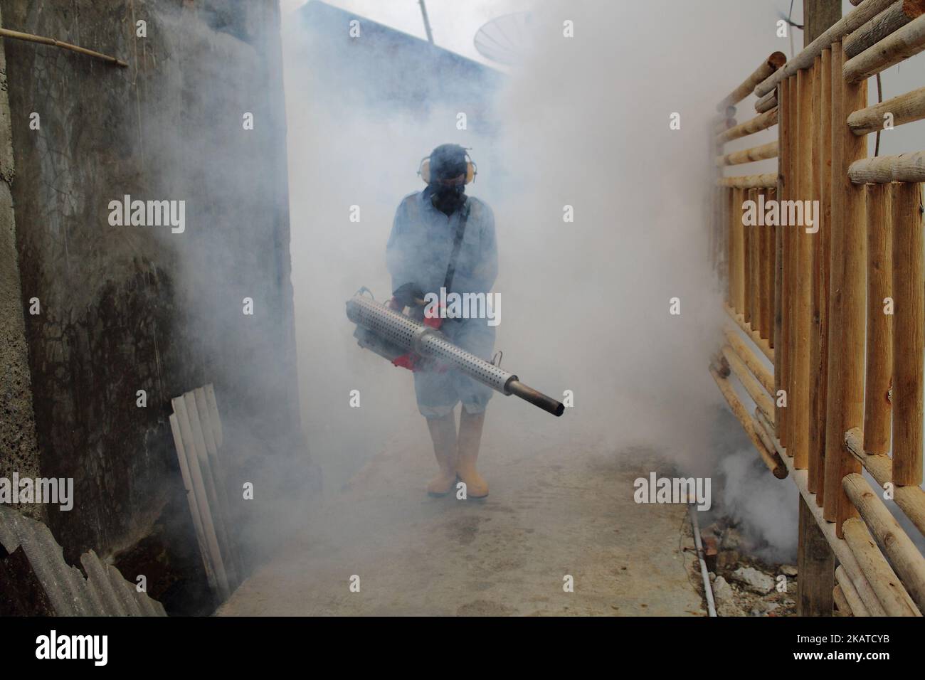 A health worker fumigation densely populated areas to prevent the ...