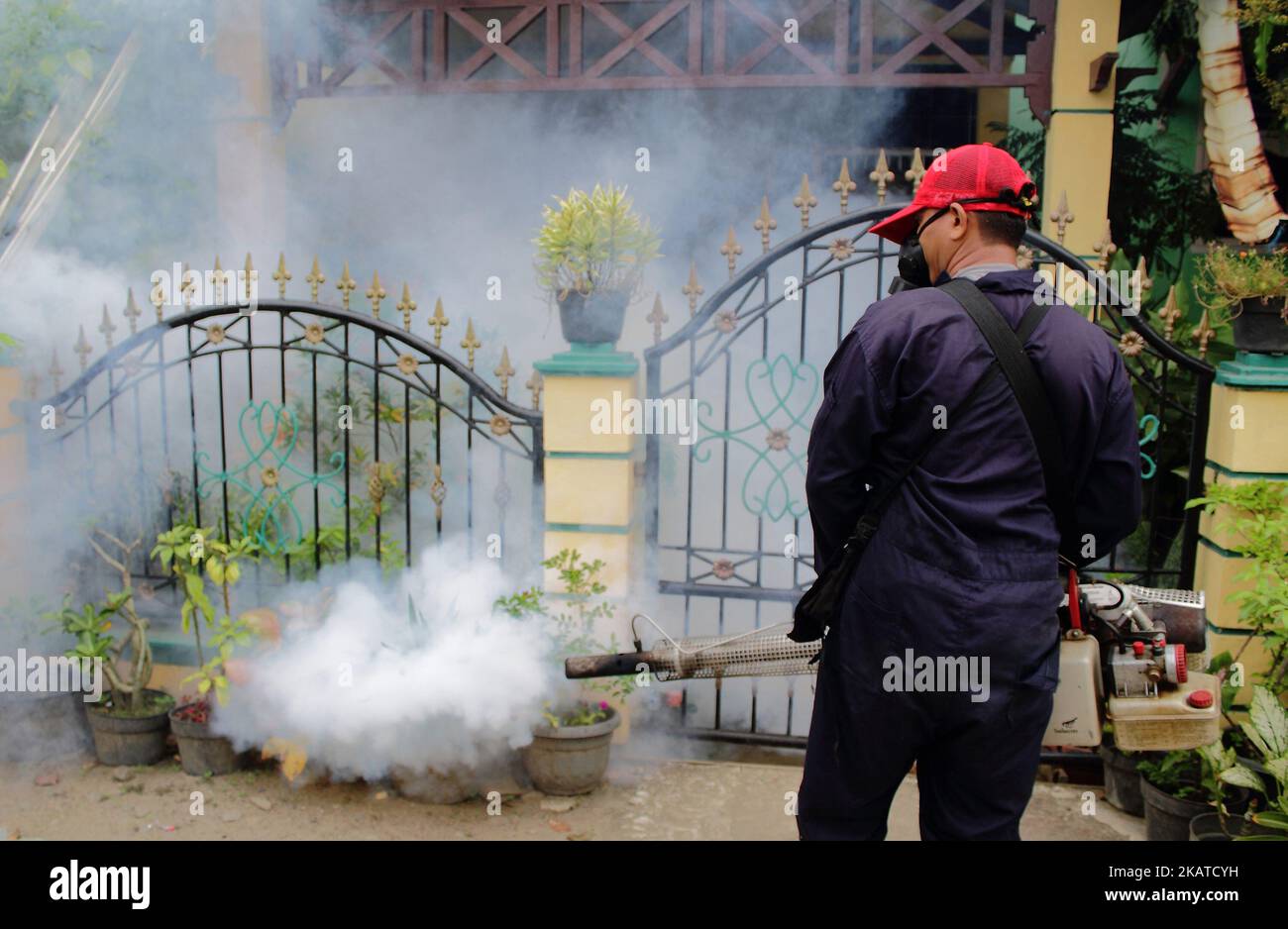 A health worker fumigation densely populated areas to prevent the ...