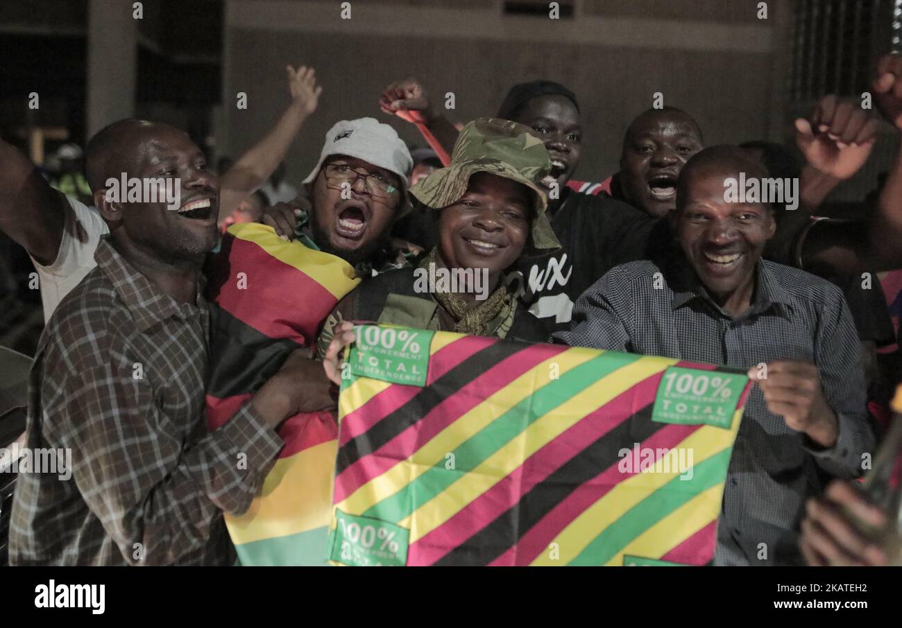 Zimbabweans drink, sing, and dance as they celebrate at night at an ...