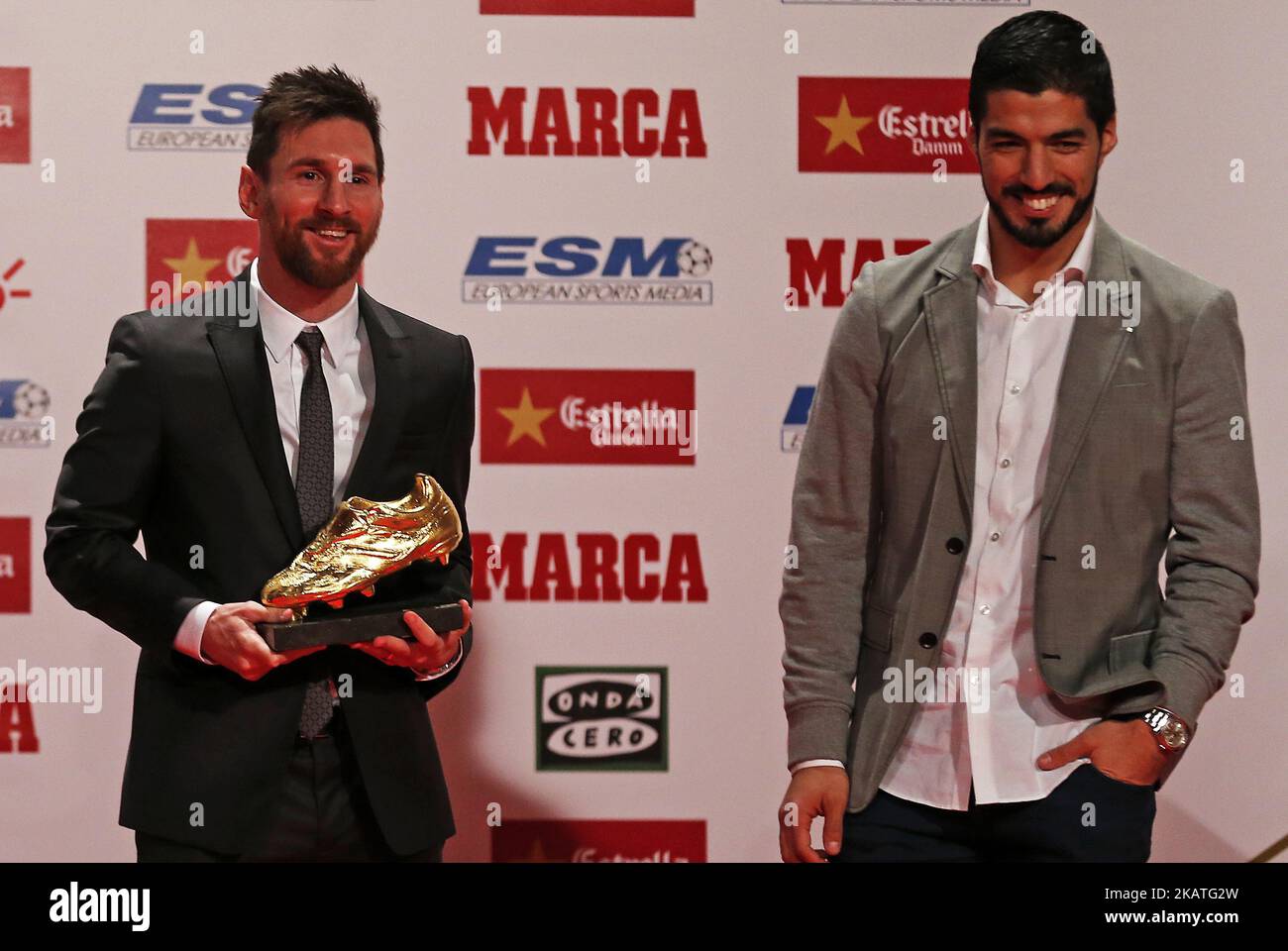 Barcelona football player Luis Suarez (R) gives the Golden Boot award ...
