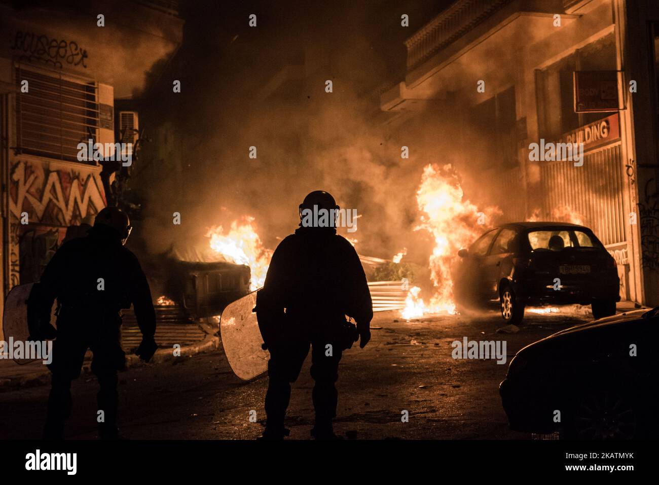 A petrol bomb explodes next to riot police during clashes following an ...