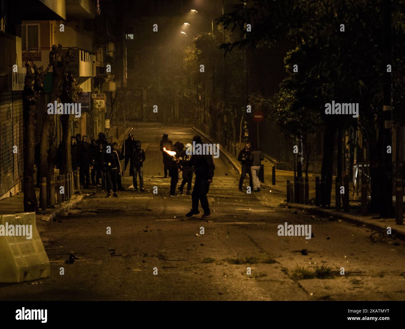 A petrol bomb explodes next to riot police during clashes following an ...