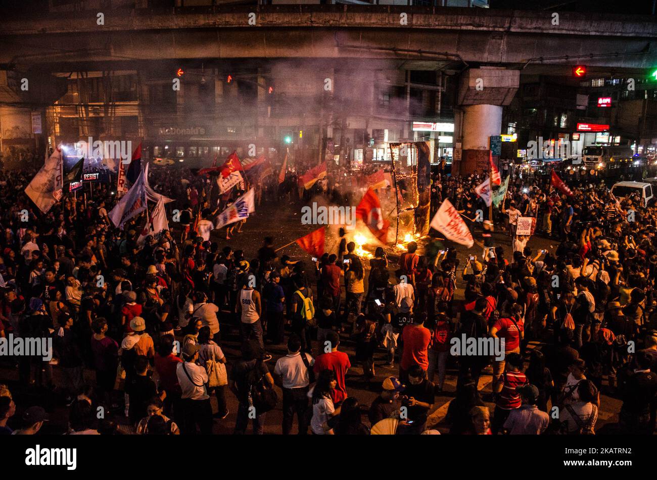 Activists burn an effigy of President Duterte during the International ...