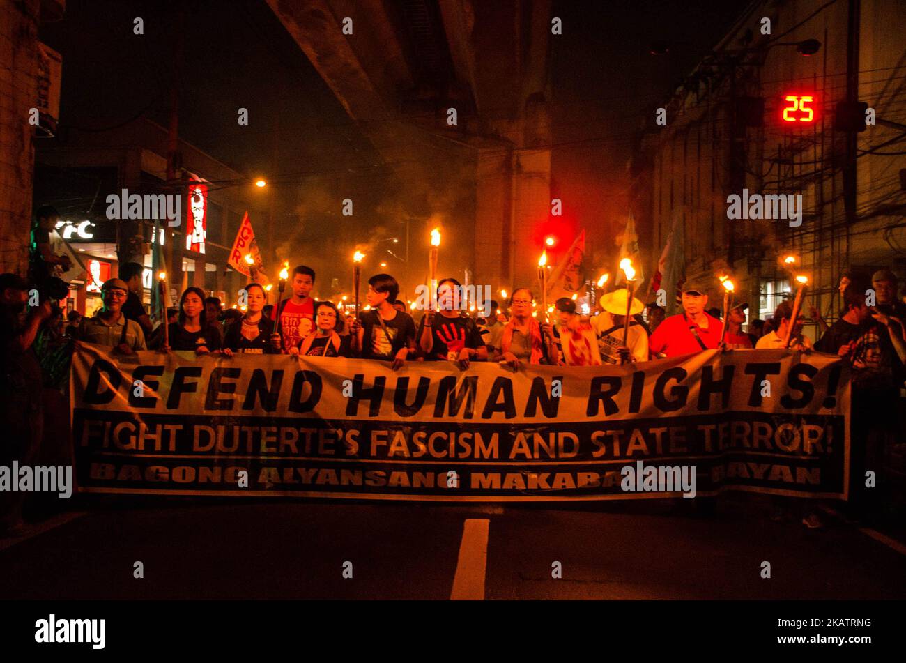 Human rights activists chant and hold placards as they head towards ...