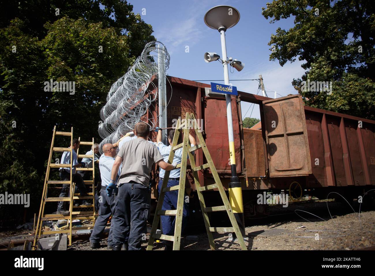 (9/14/2015) Roeszke, Hungary. Police putting barbed wire on train ...