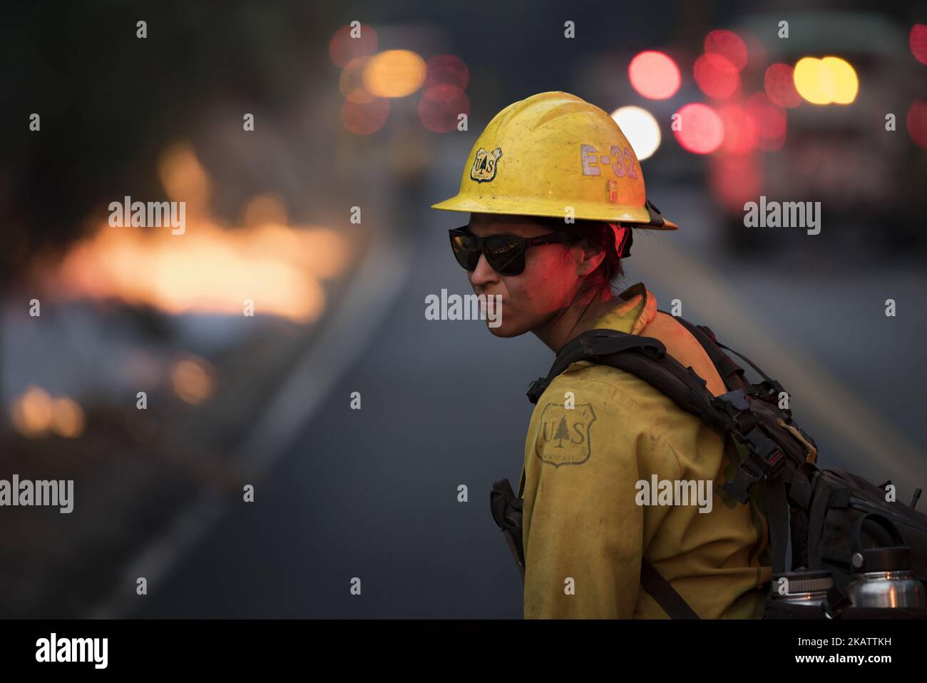 A firefighter keeps watch as the Thomas wildfire burns near Carpinteria ...