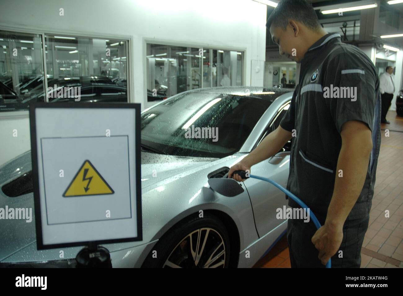 BMW high-voltage technician carries battery charging on the car at BMW ...