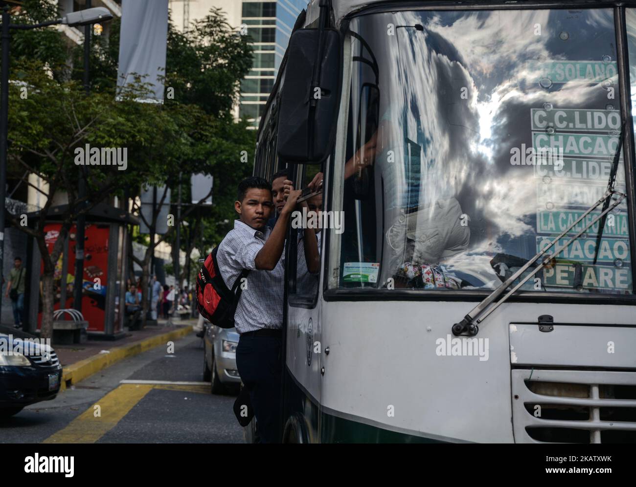 Locals use public transport buses during a power cut in Caracas on ...