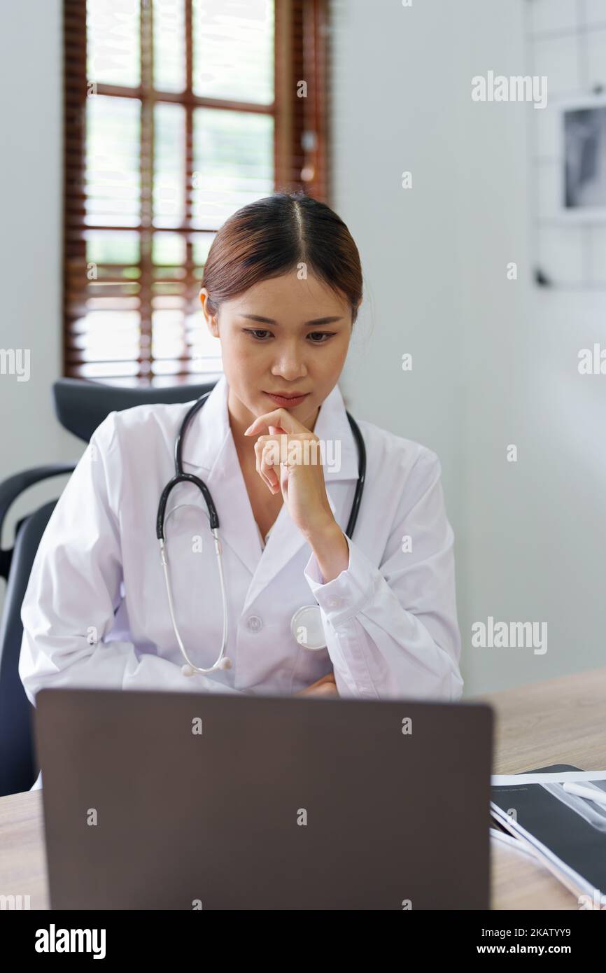 Portrait of an Asian doctor using a computer Stock Photo - Alamy
