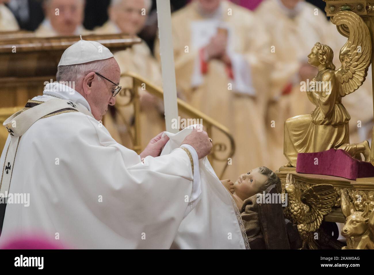 Pope Francis kisses a statue of Baby Jesus as he celebrates the ...