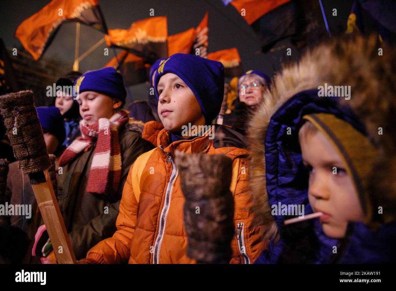 Kids carry a torches during the rally. Supporters and members of ...