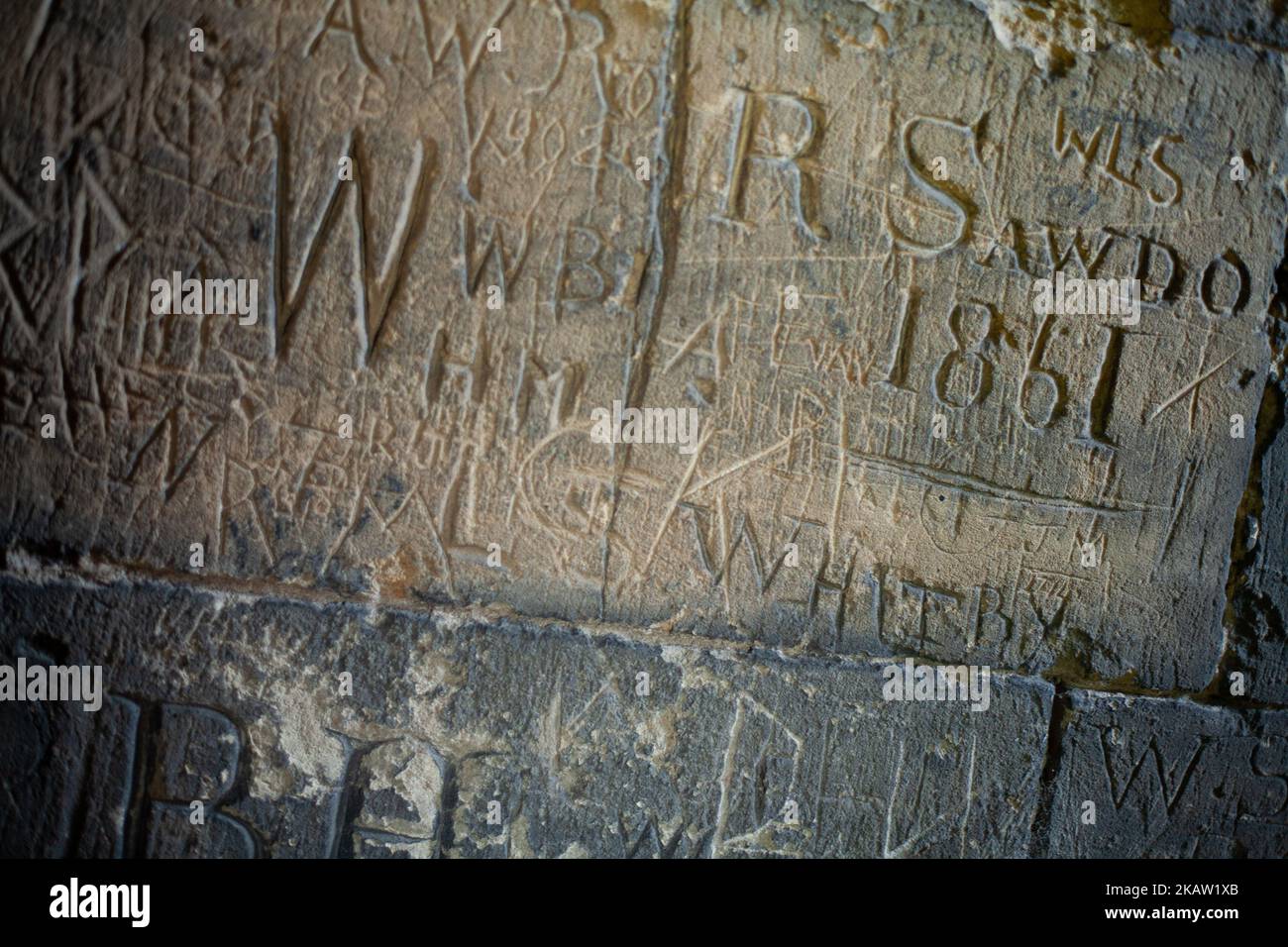 An Old brick wall with names carved into it 150 years Stock Photo - Alamy