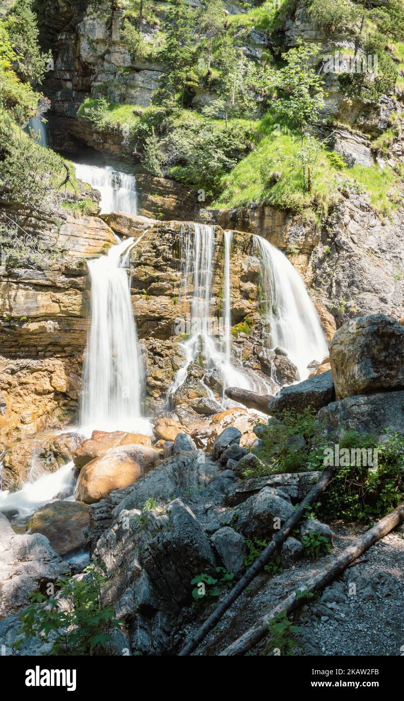 A beautiful waterfall flowing downstream off a cliff in a forest Stock ...