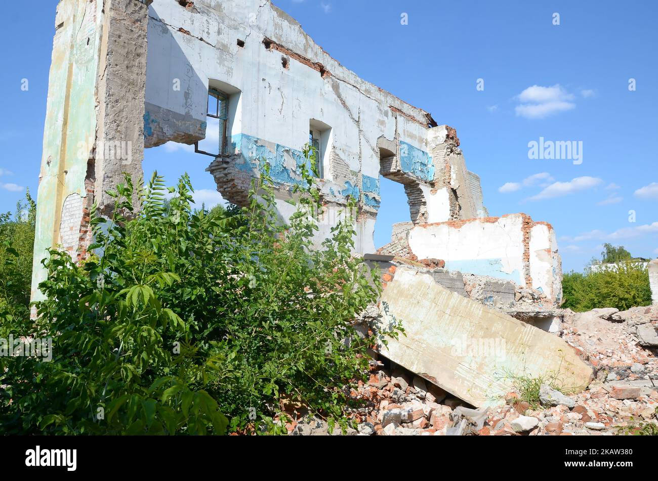 Collapsed industrial multistorey building in daytime. Disaster scene ...