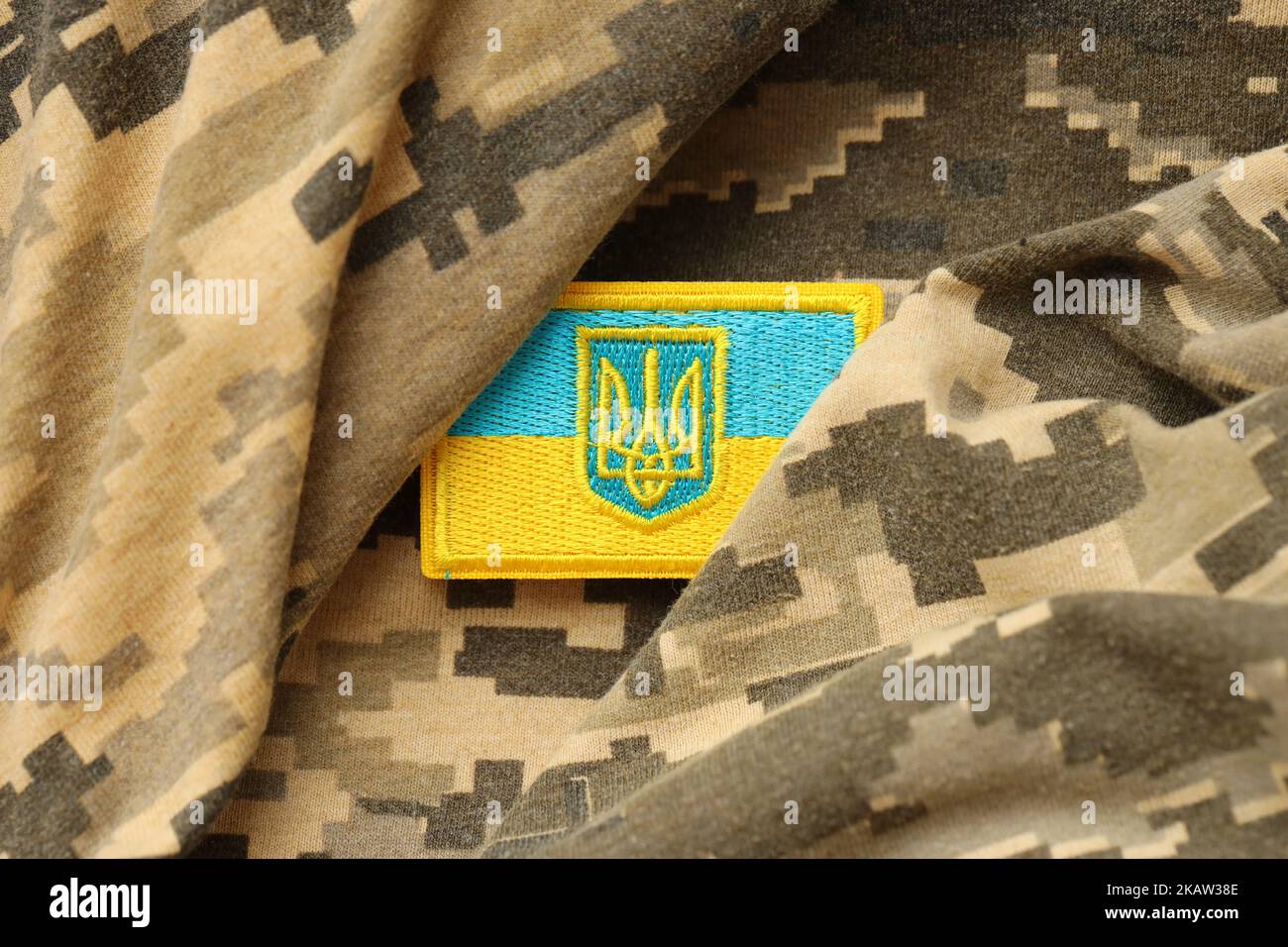 Pixeled digital military camouflage fabric with ukrainian flag and coat ...