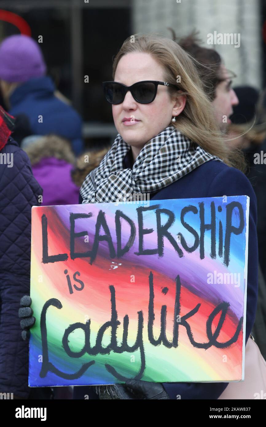 Woman holding a sign saying 'Leadership is Ladylike' as hundreds take ...