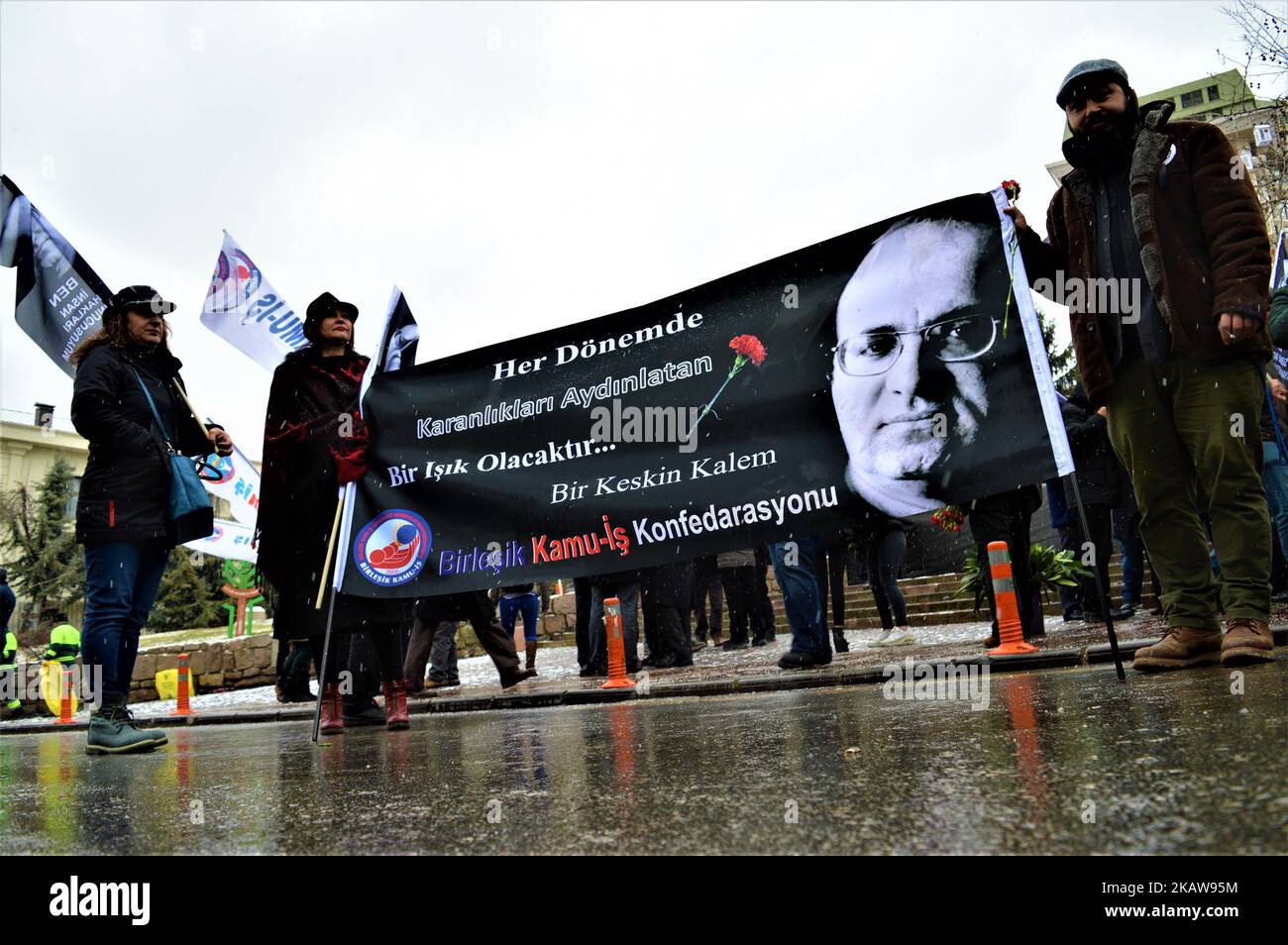 People hold a banner as they gather on the spot, where Turkish ...