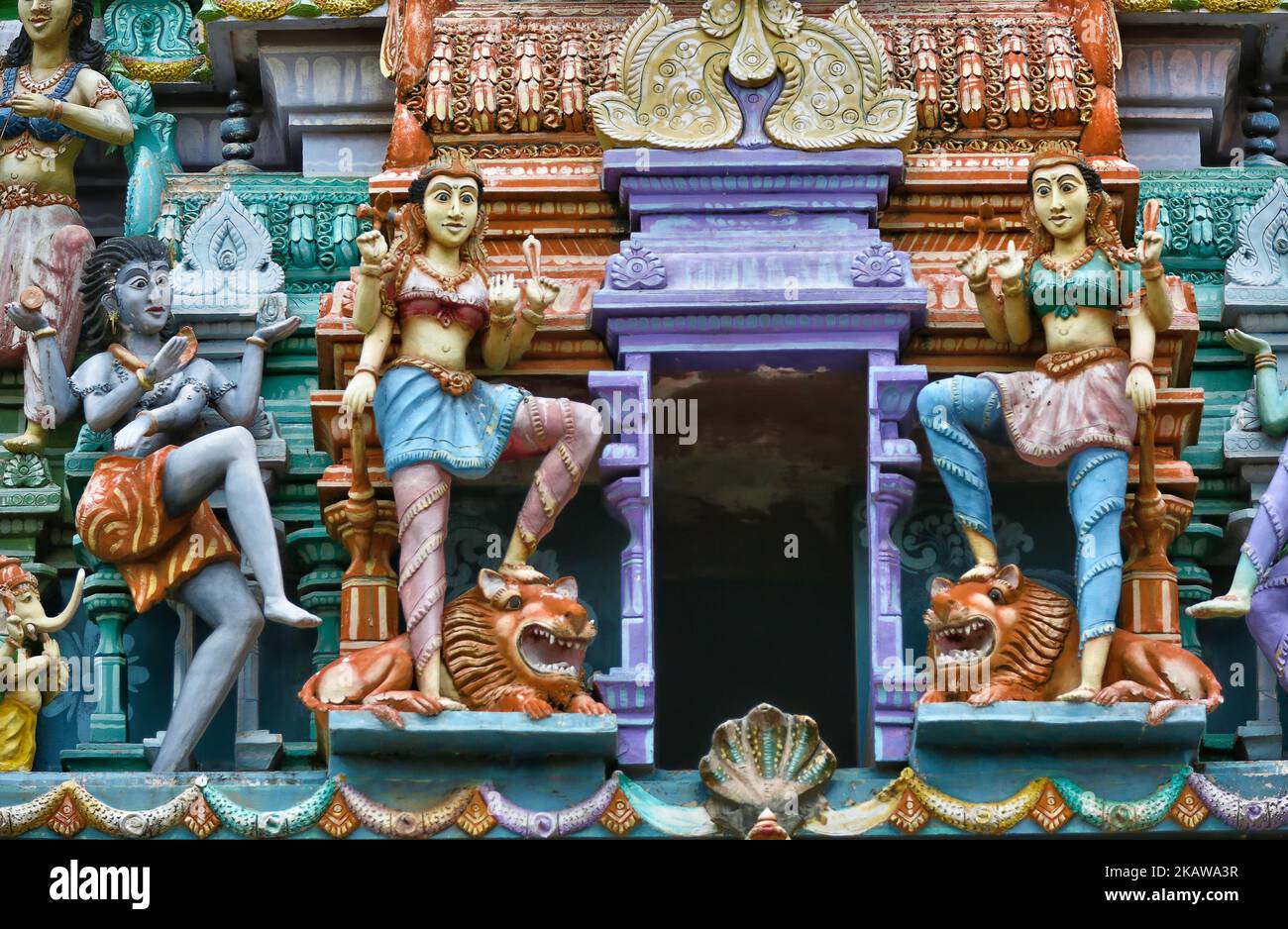 Intricate figures of Hindu deities adorn gopuram (tower) of the Sri Muthumariamman Hindu temple ...