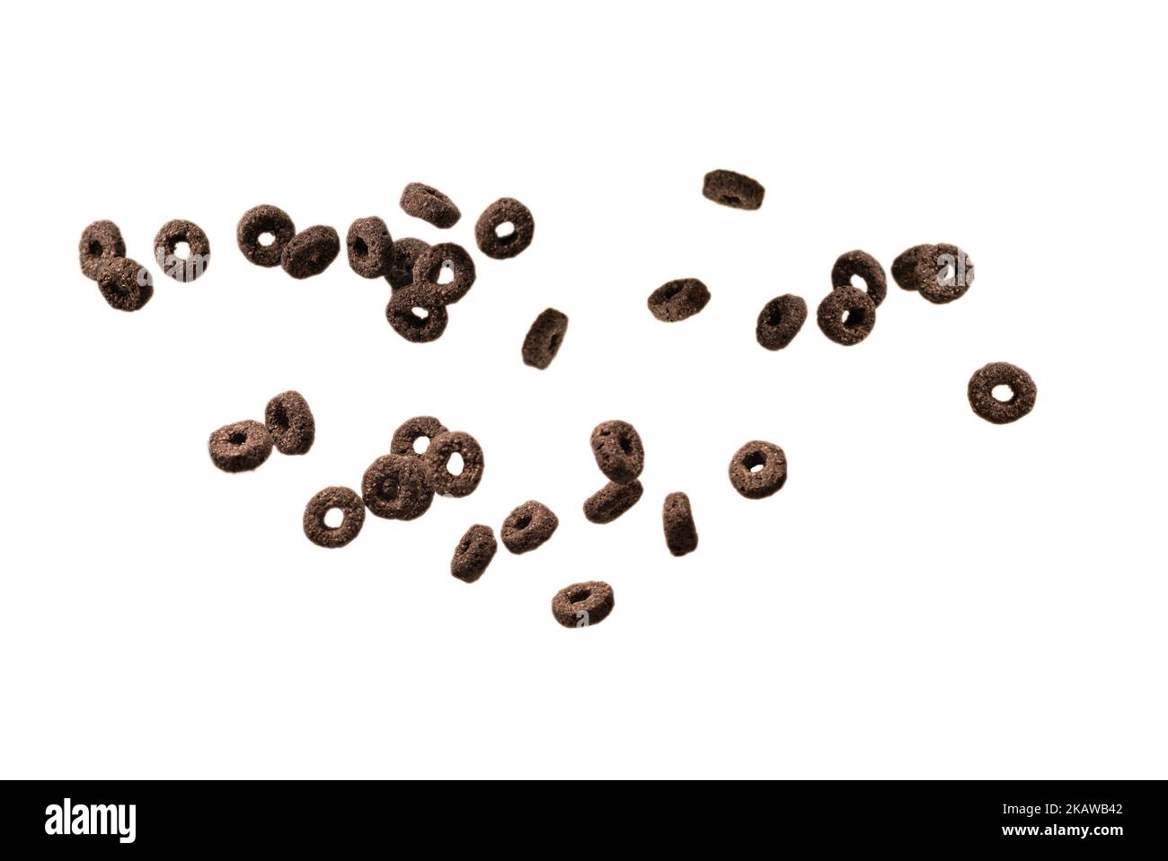 Chocolate rings cereal spill out into a bowl. Breakfast. Isolated on a ...