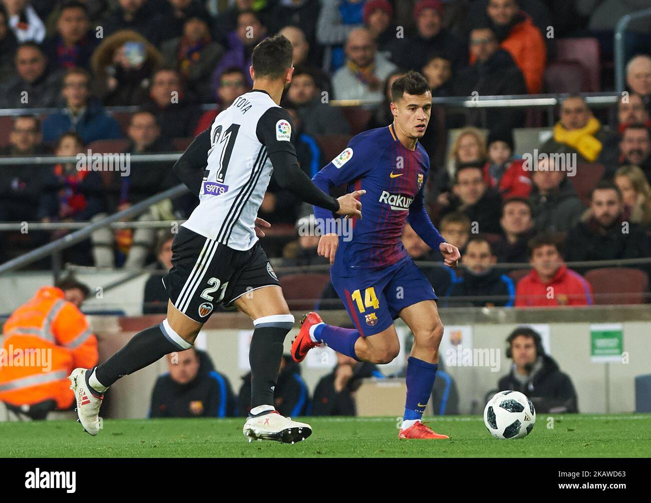 Philippe Coutinho of FC Barcelona and Martin Montoya of Valencia CF ...