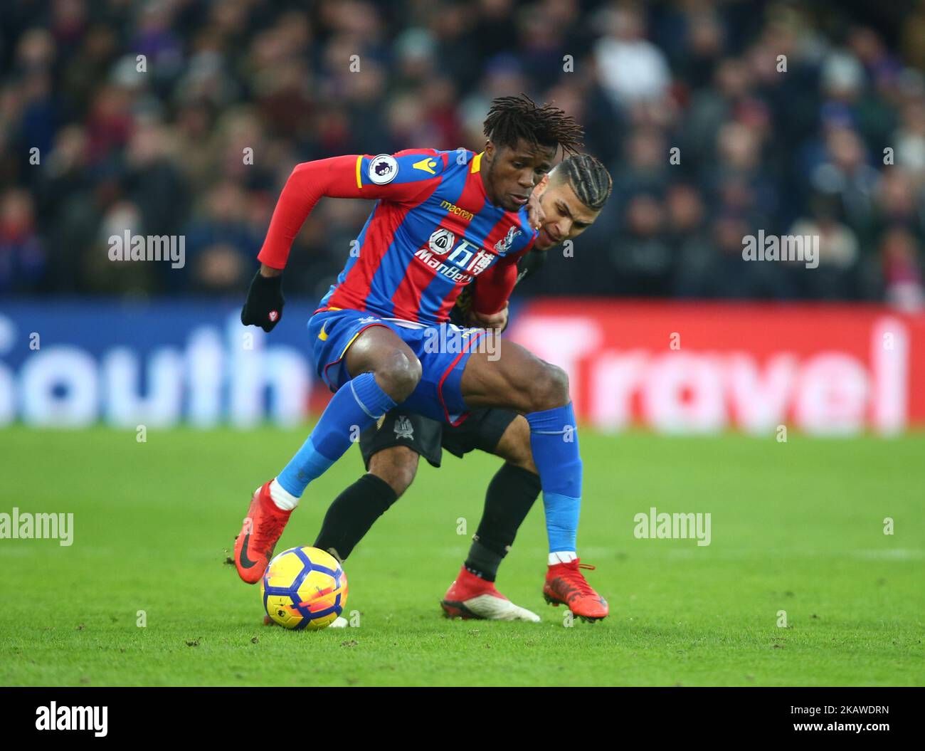 Crystal Palace's Wilfried Zaha holds of Newcastle United's DeAndre ...