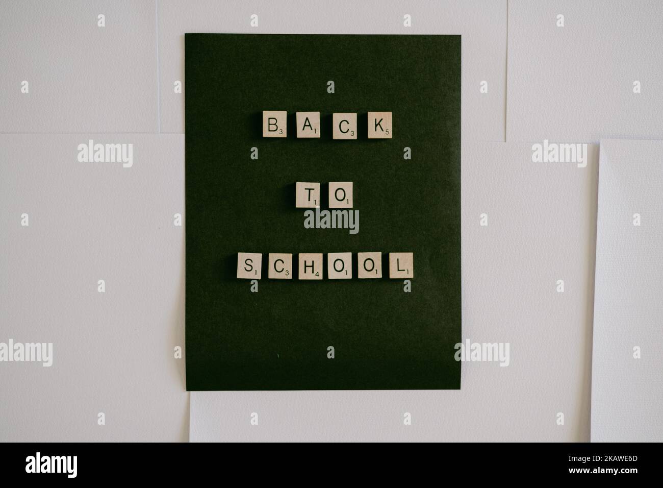 A top view of "back to school" scrabble letters on a green sheet Stock ...