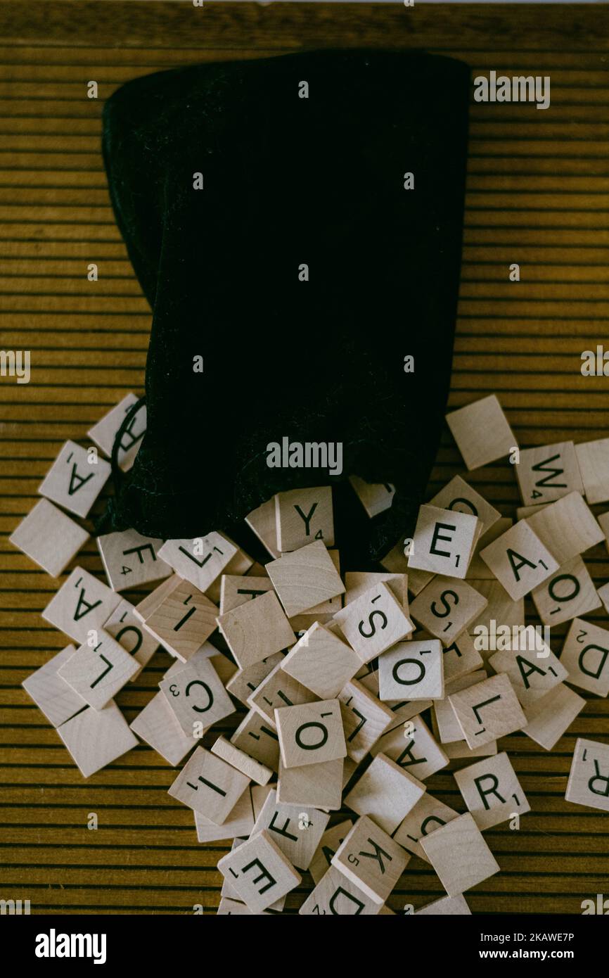 A vertical shot of wooden scrabble letters blocks in a sack Stock Photo ...