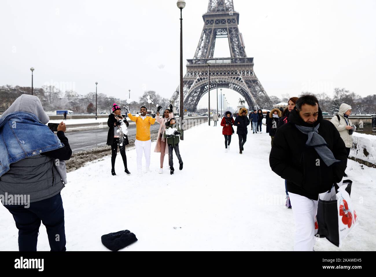 People walk through the snow in Paris, France on February 7, 2018 ...