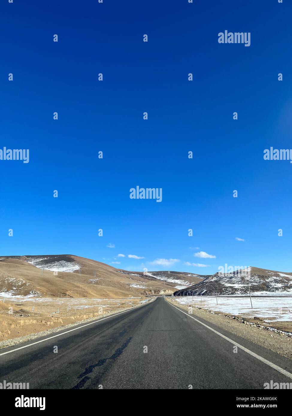 A vertical shot of the asphalt road of highway 318 from Litang County ...