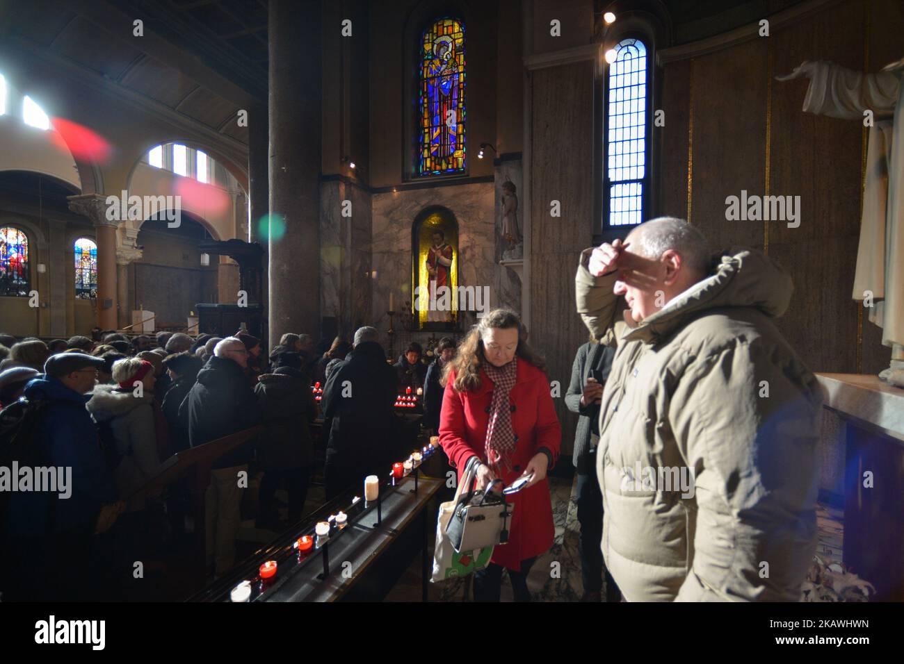 A view of the crowd at the chapel with the statue of patron saint of ...