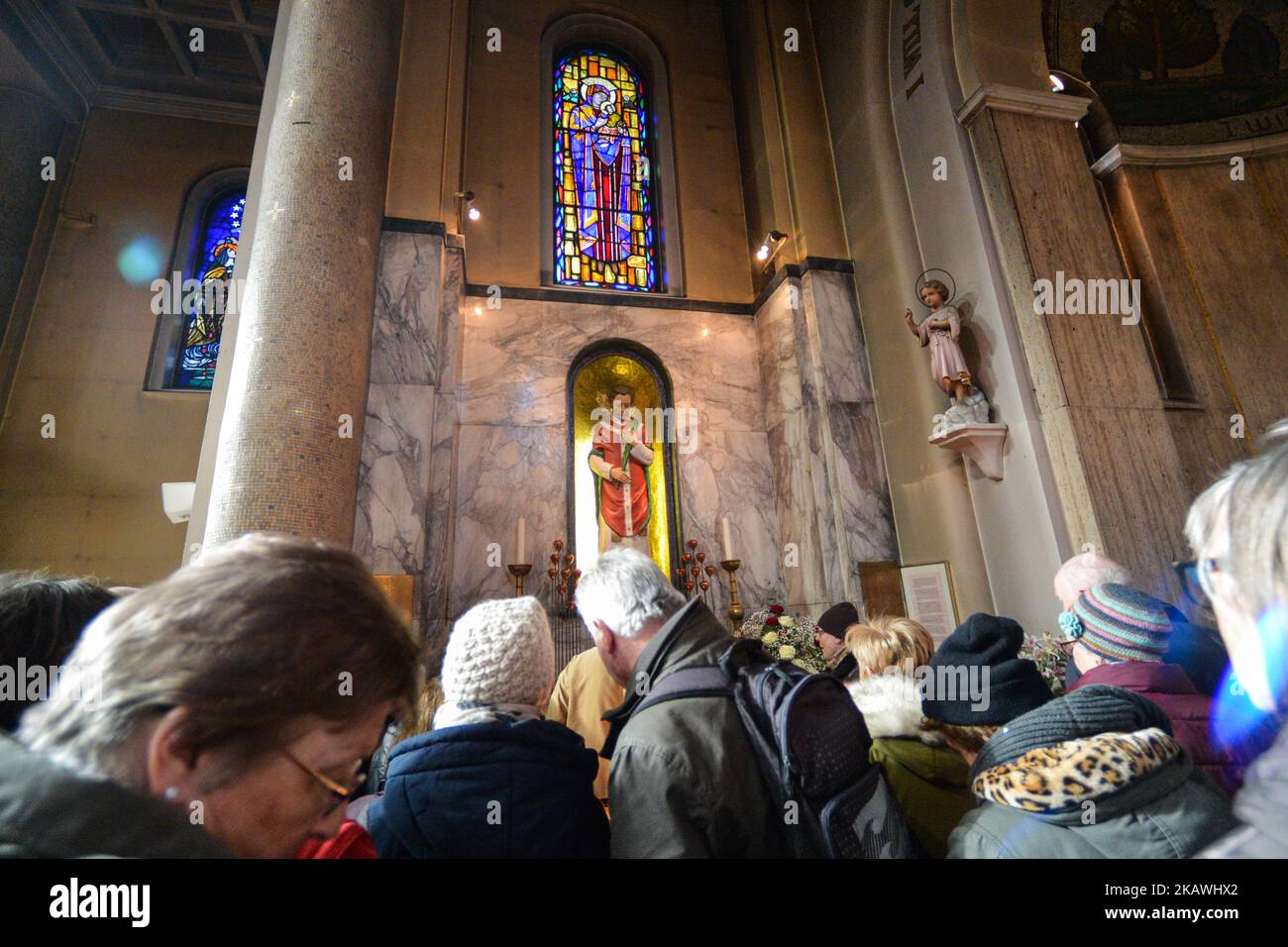 A view of the crowd at the chapel with the statue of patron saint of ...