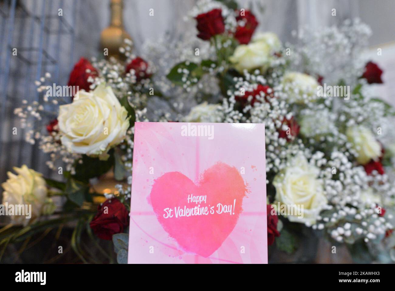 A card and flowers at the chapel with the statue of patron saint of ...