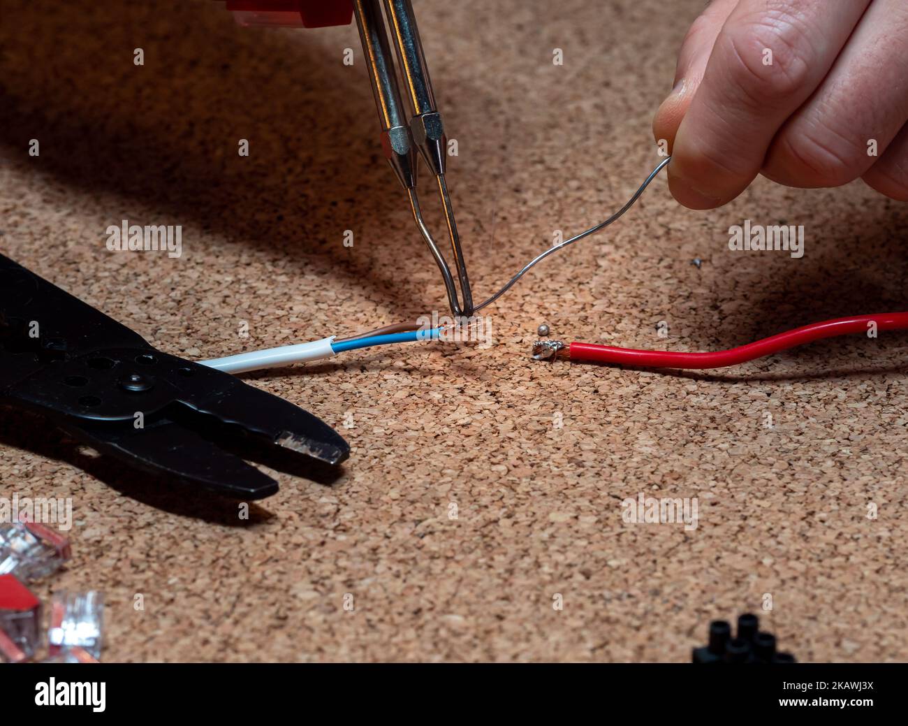 soldering - connecting wires with tin and soldering iron, workshop, in ...
