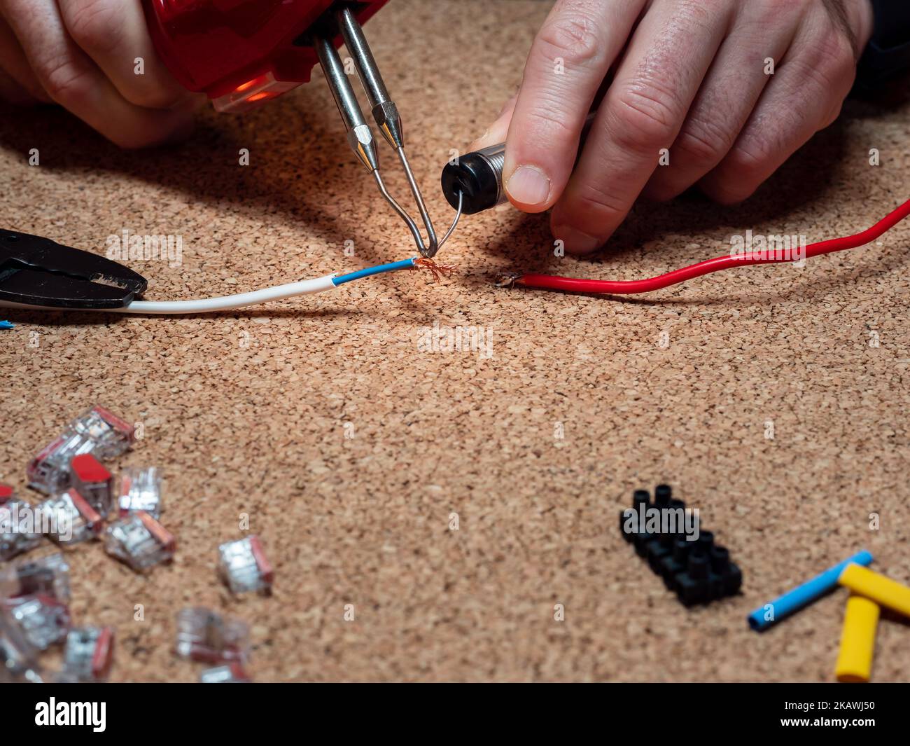 soldering - connecting wires with tin and soldering iron, workshop, in ...