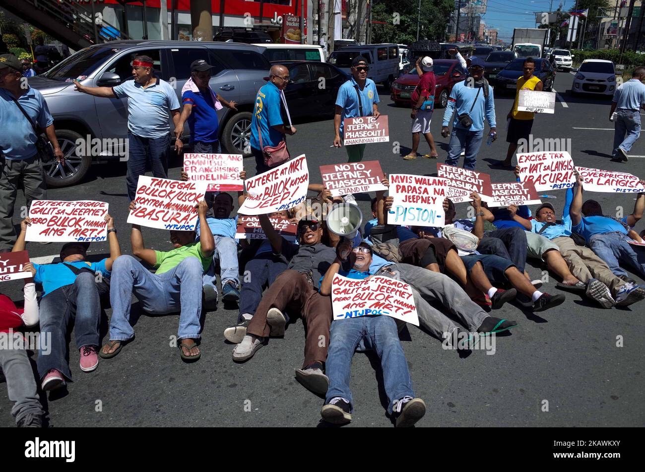 Jeepney drivers belonging to the activist jeepney driver group PISTON ...
