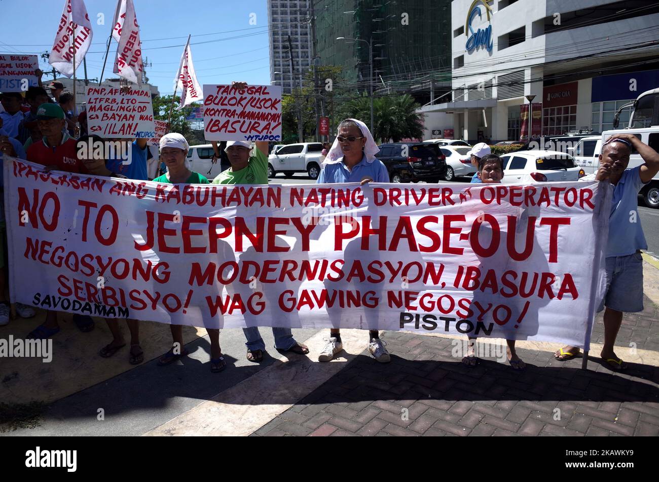 Jeepney drivers belonging to the activist jeepney driver group PISTON ...