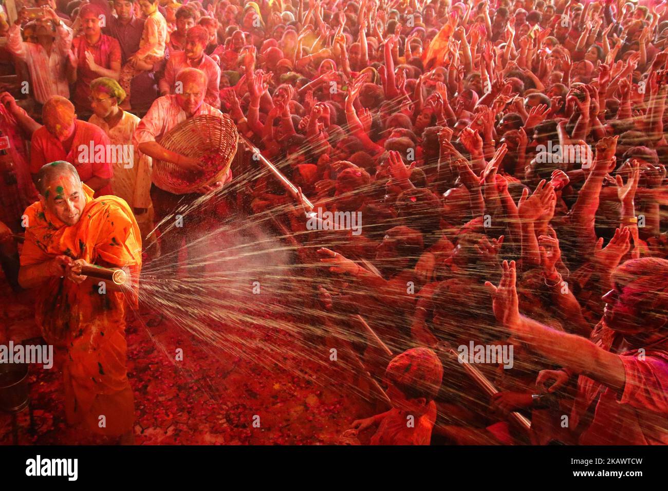 Priest water gun on devotees on the occasion of Holi festival ...