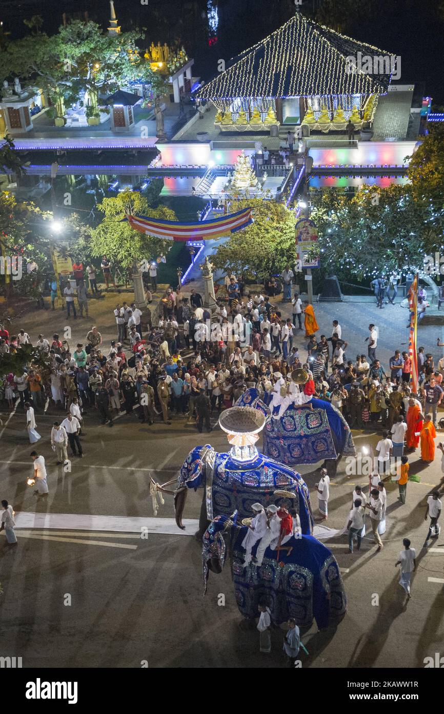 The sacred Buddhist relic casket is carried out by an elephant led by ...