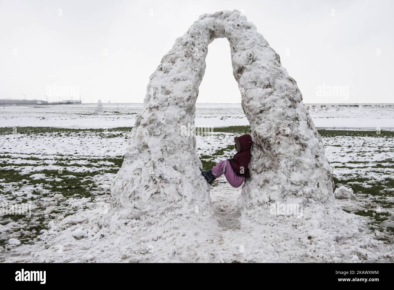 The child is sitting in the middle of the snow gate at The south park ...