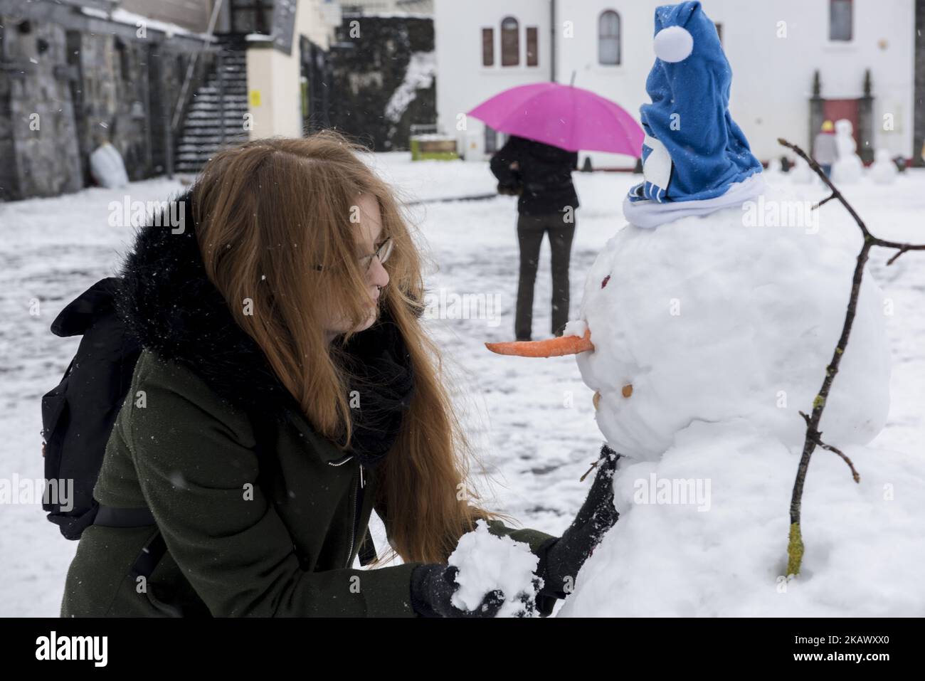 Girl make the snowman at The Spanish Arch which was covered with snow ...