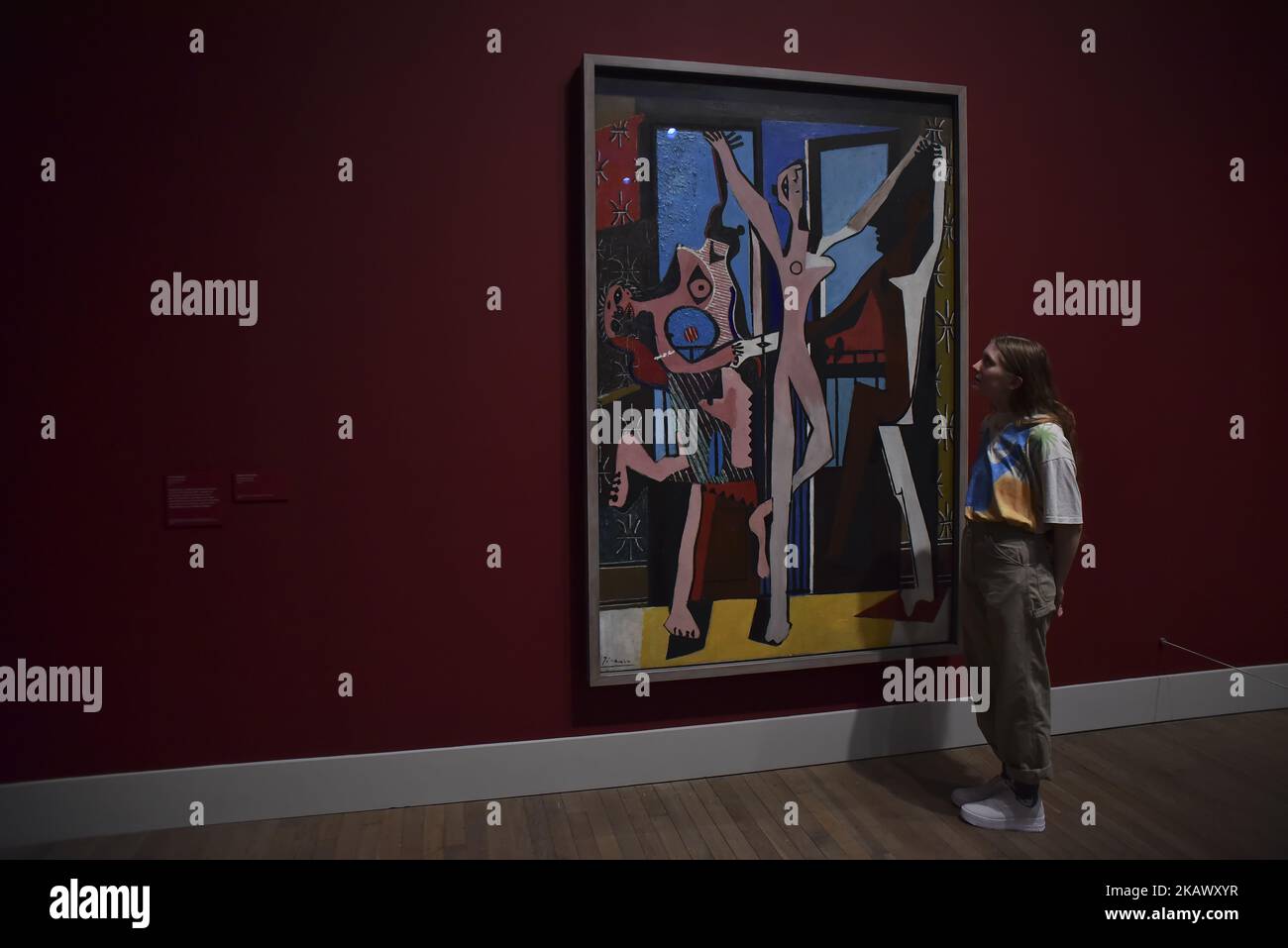 A woman poses in front of 'The Three Dancers' by Pablo Picasso at the ...