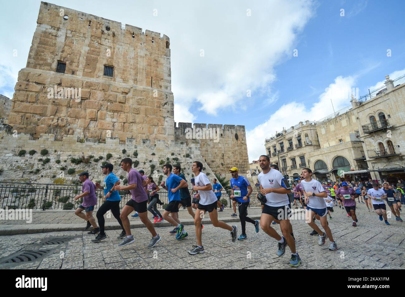 Athletes run inside Jerusalem's Old City, near the Jaffa Gate and the ...