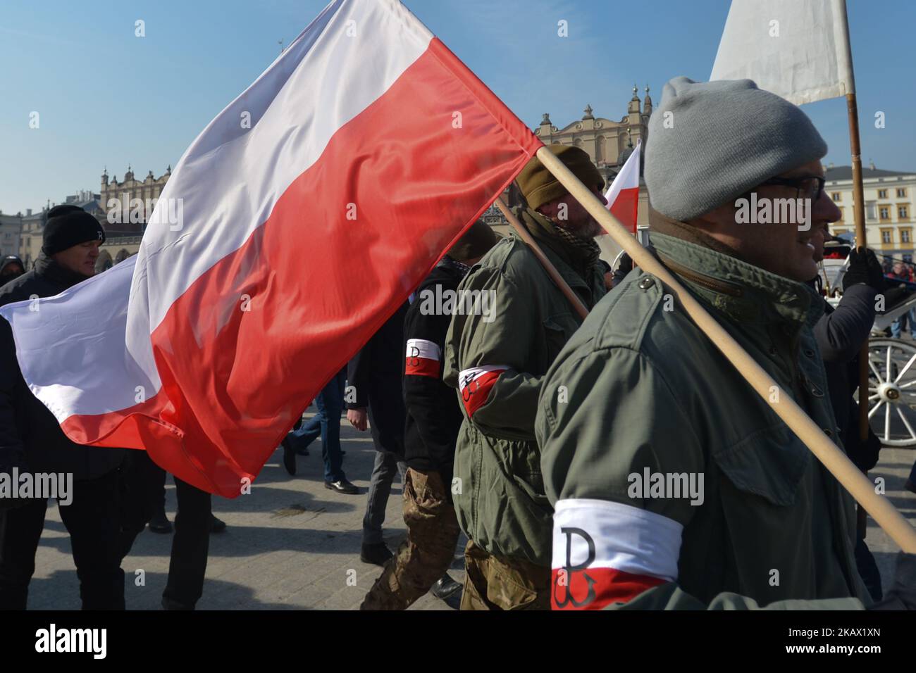 A man carries the Polish National Flag during celebrations of the ...
