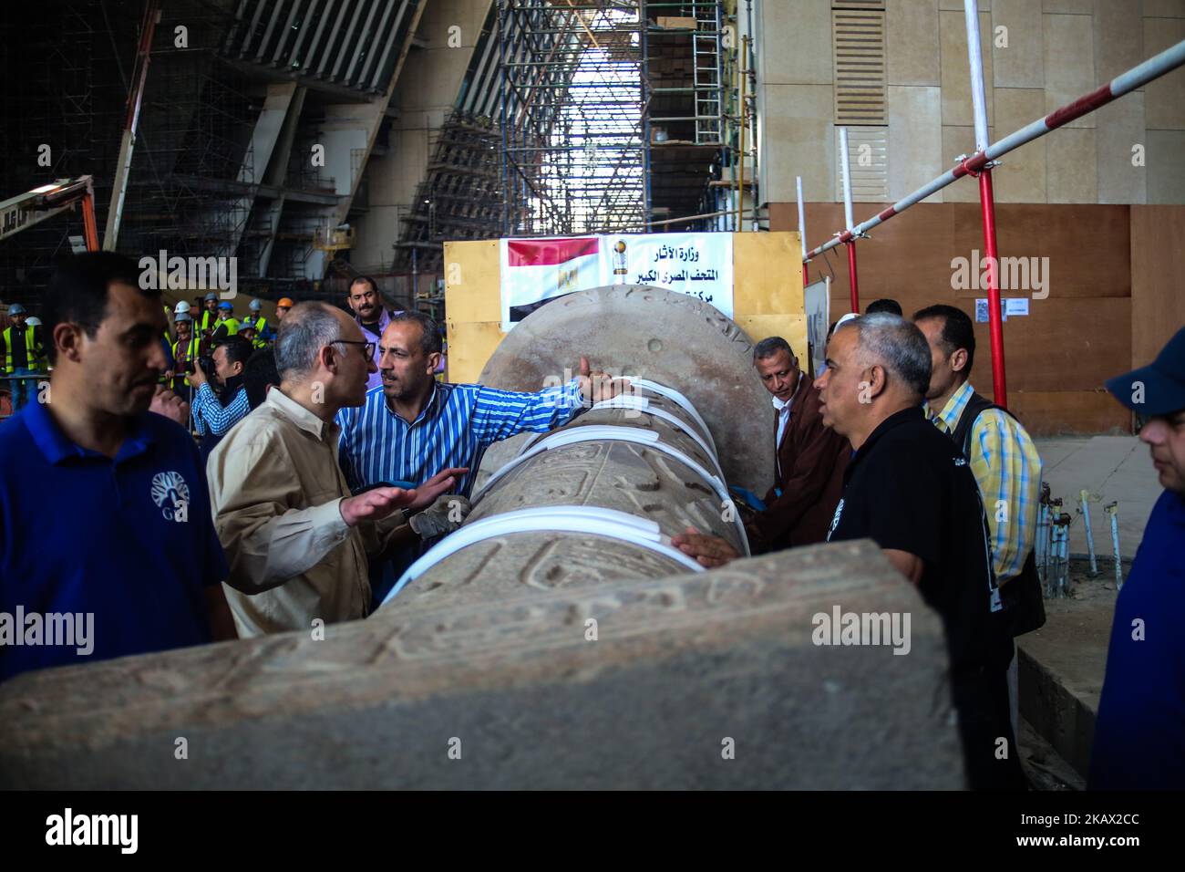 Members of the Grand Egyptian Museum Conservation Centre inspect the ...