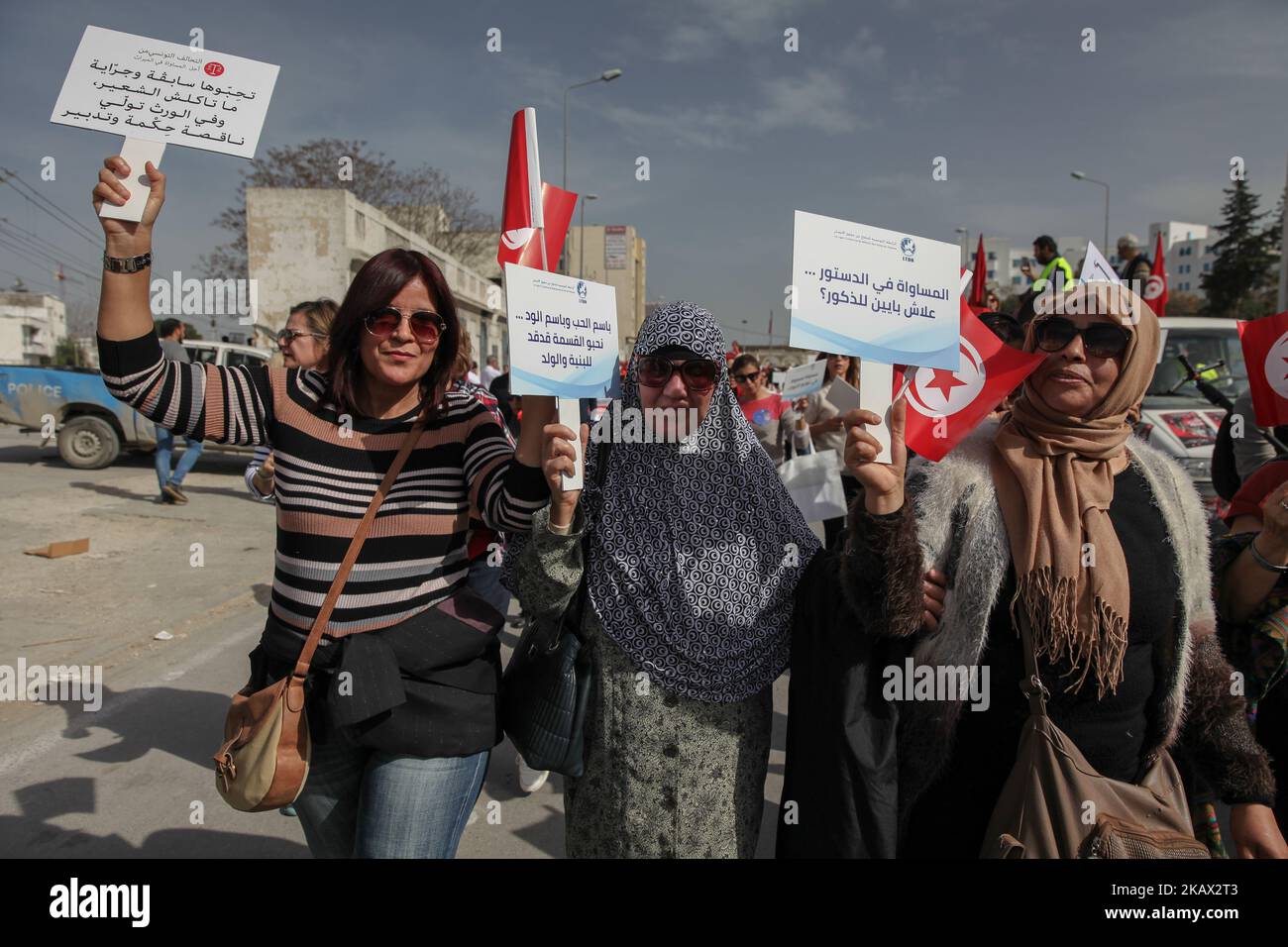 Women chant slogans while raising placards which read in Arabic ...