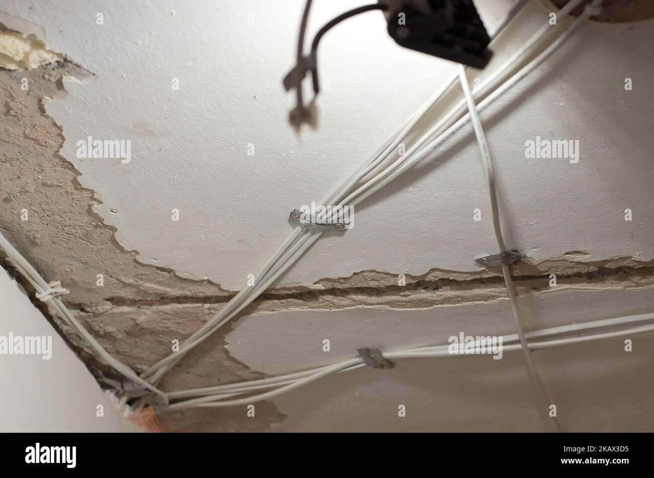 Fixing new wiring to the ceiling. Replacement and distribution of ...