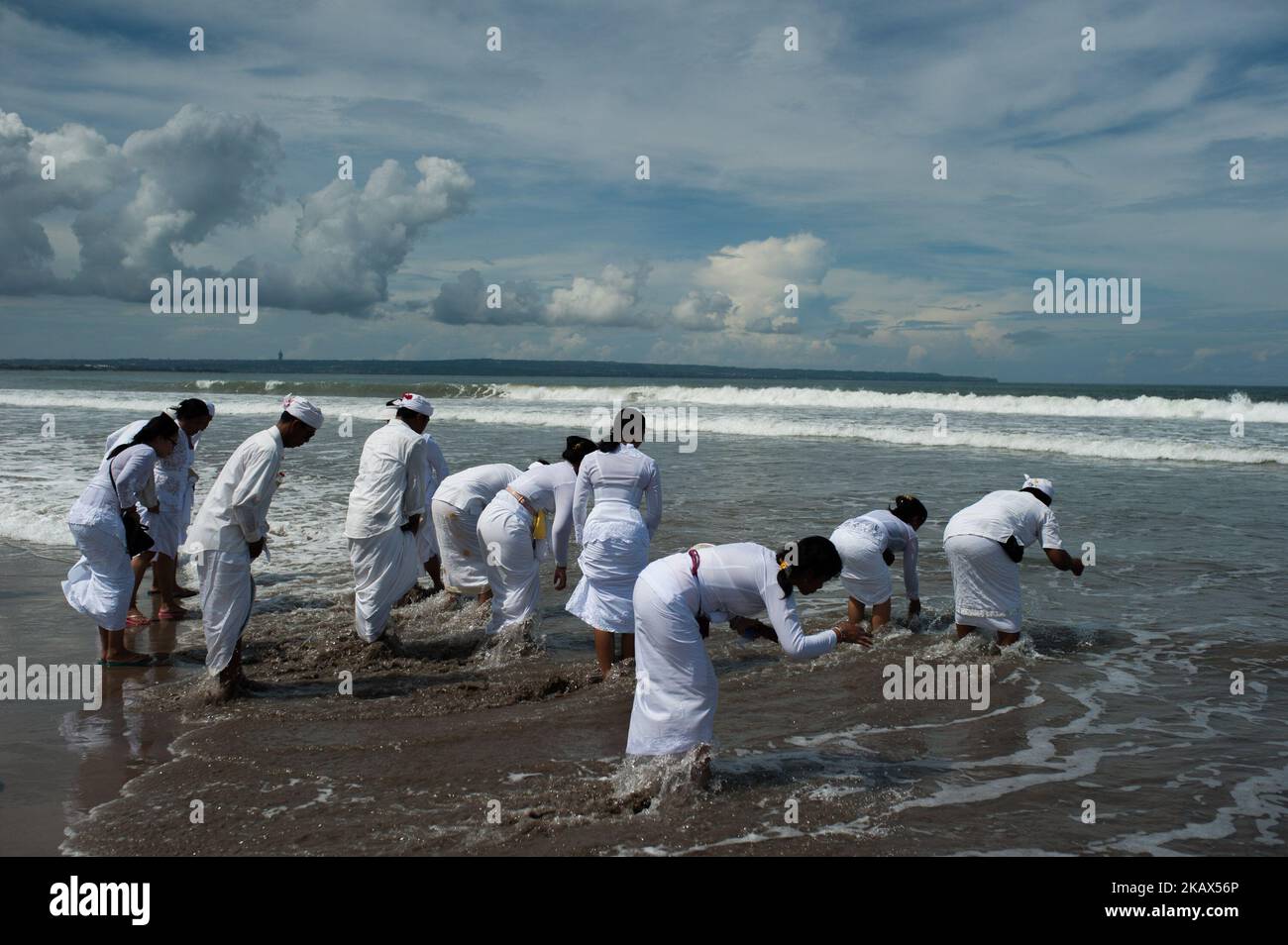 Balinese Hindus are conducting prayers at Petitenget beach on March 14 ...